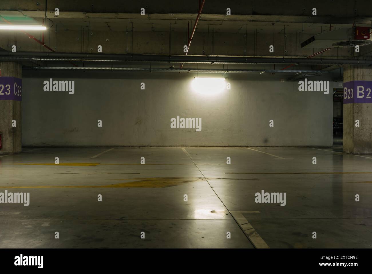 Parking lot with overhead dim light, underground parking garage Stock ...