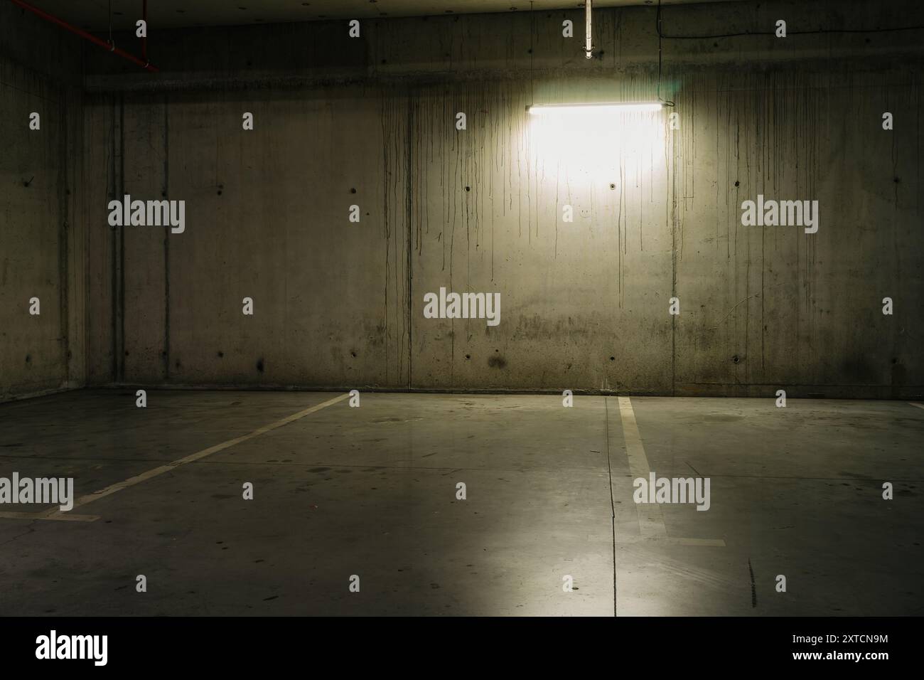 Parking lot with overhead dim light, underground parking garage Stock ...