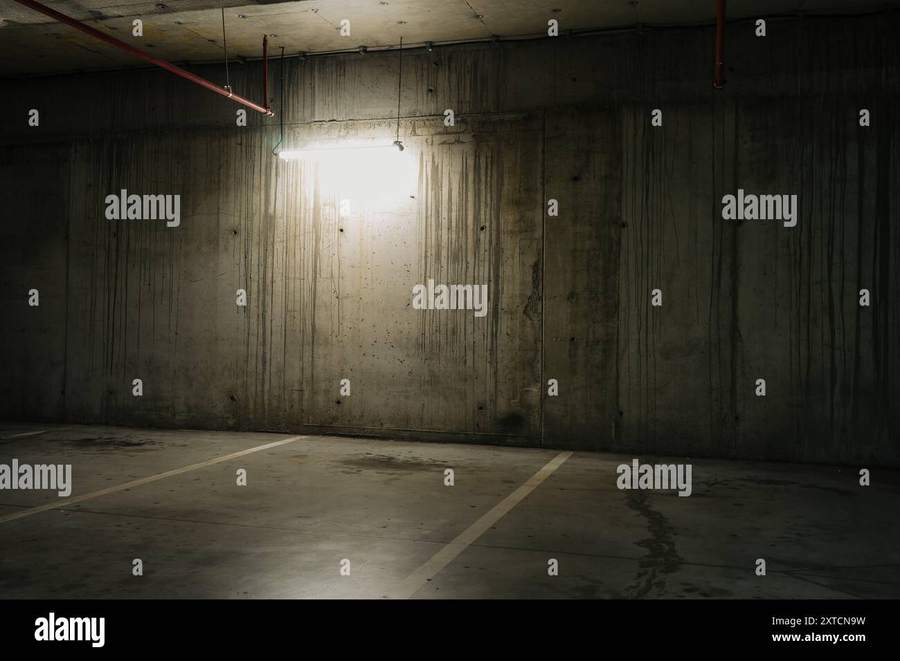 Parking lot with overhead dim light, underground parking garage Stock ...