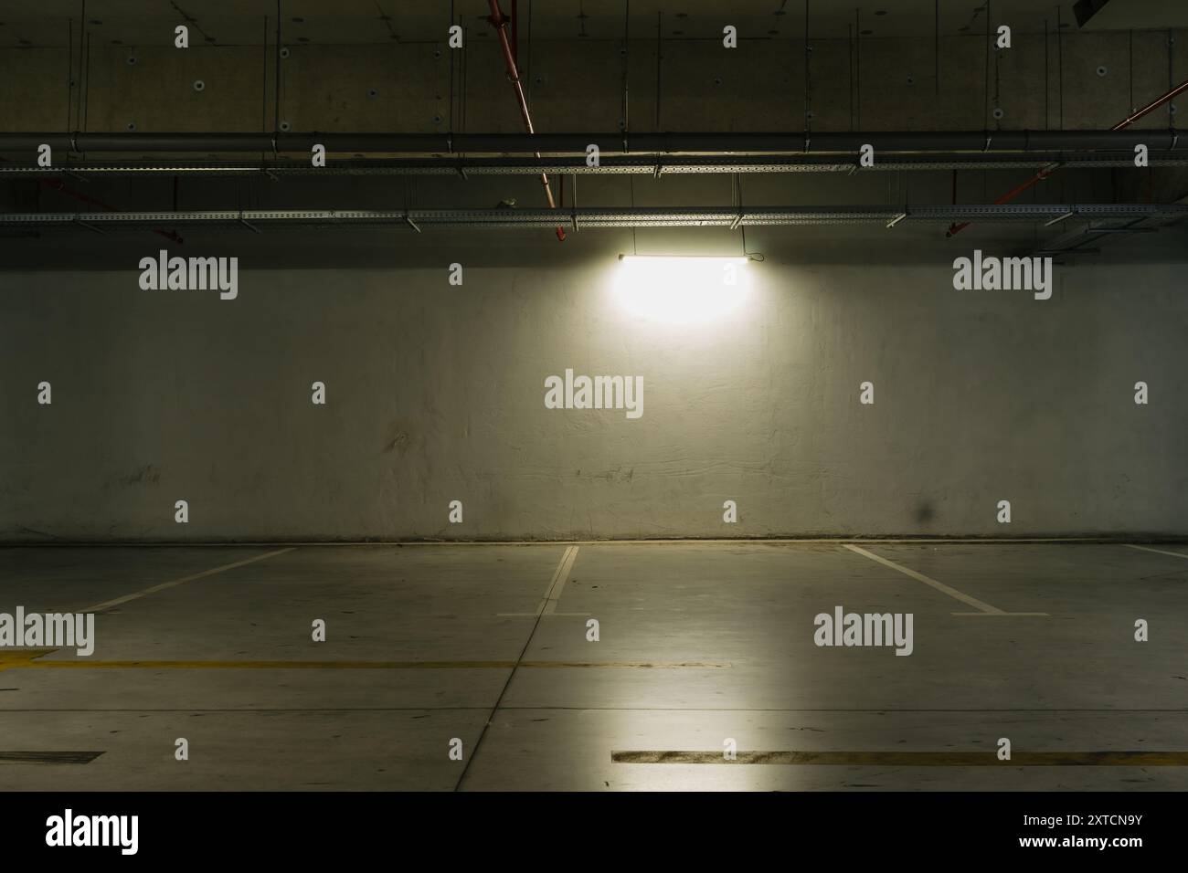 Parking lot with overhead dim light, underground parking garage Stock ...