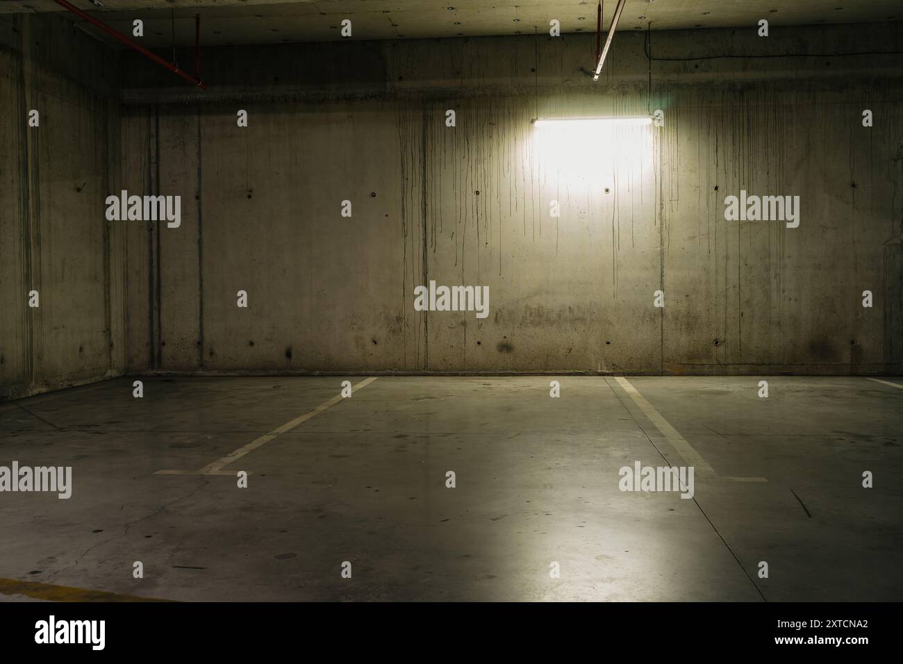 Parking lot with overhead dim light, underground parking garage Stock ...