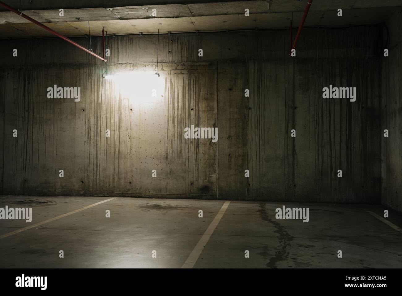Parking lot with overhead dim light, underground parking garage Stock ...