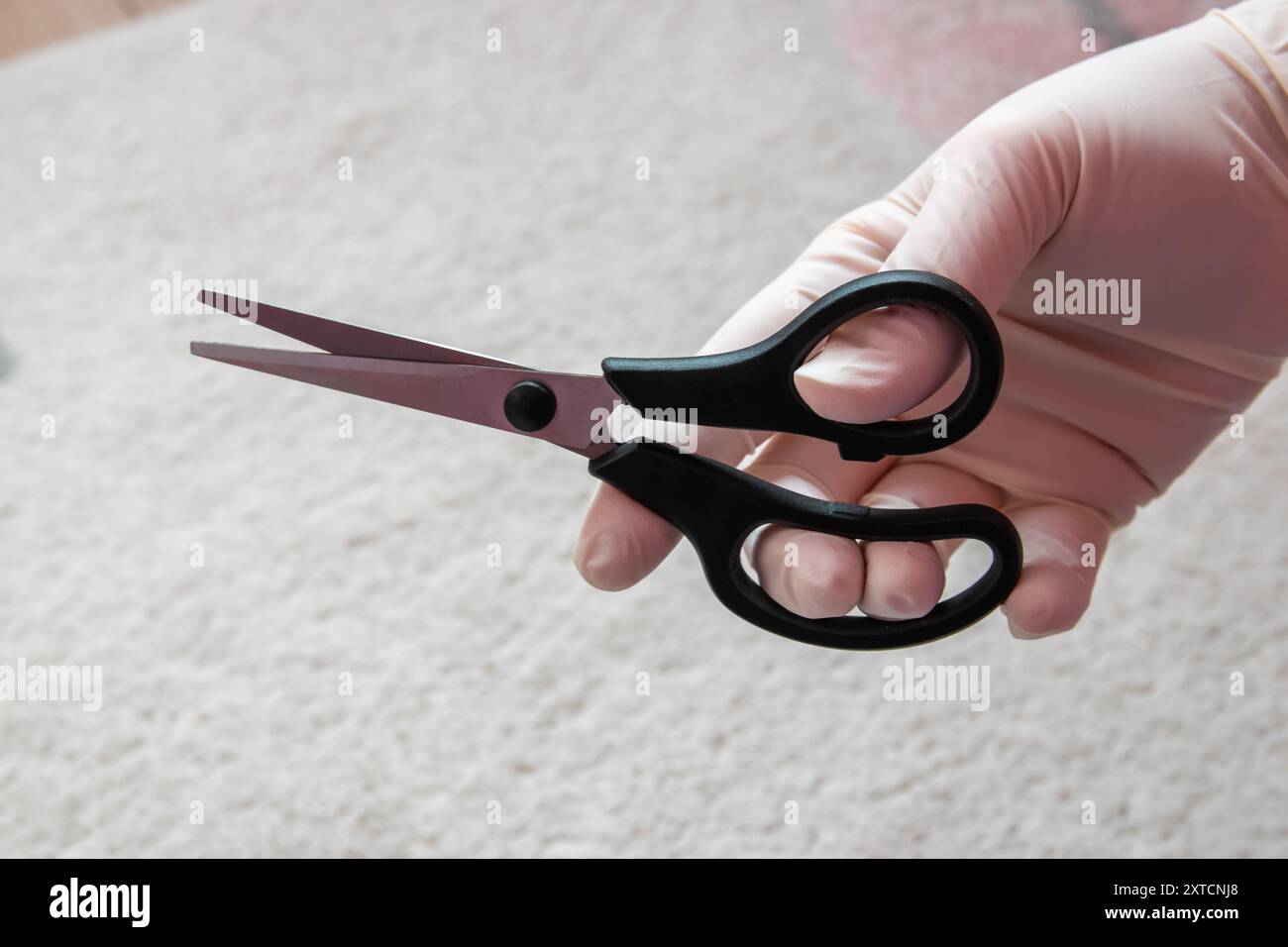 Scissors in the hand with rubber glove. Steel shears for cutting Stock ...