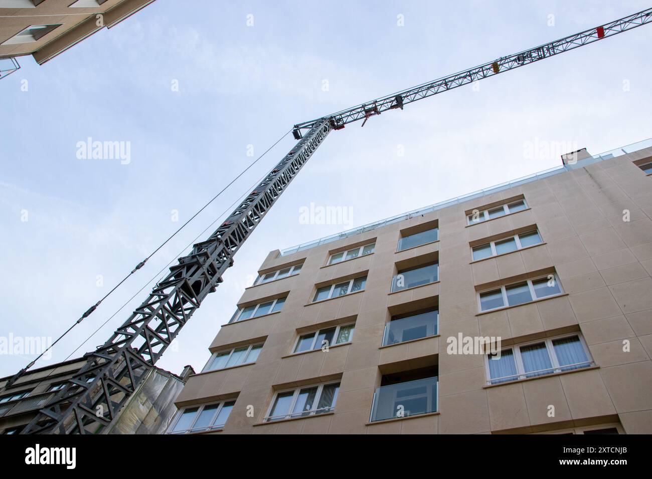 Metal building crane outside. Look above from backyard of an house to ...