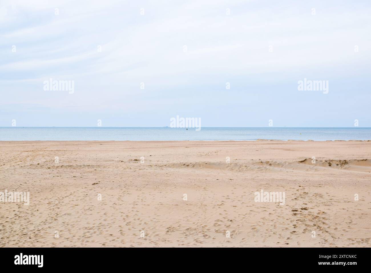 Beautiful sea with sand, yachts, waves on the water and blue sky ...