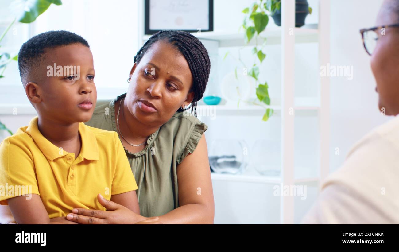 Concerned Mother and Child in a Doctor's Office Seeking Medical Advice ...