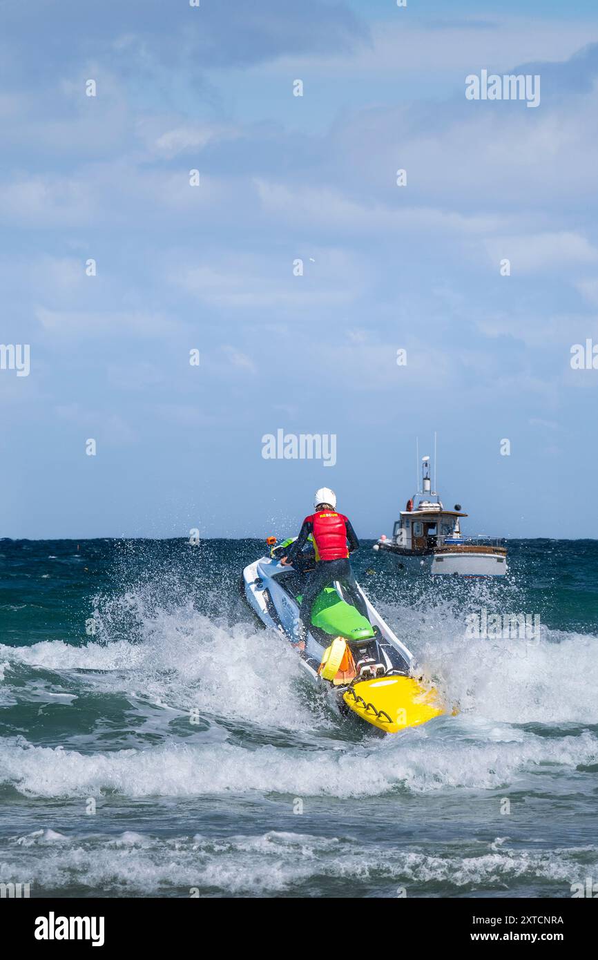 A RNLI Royal National Lifeboat Institution Lifeguard patrolling off ...