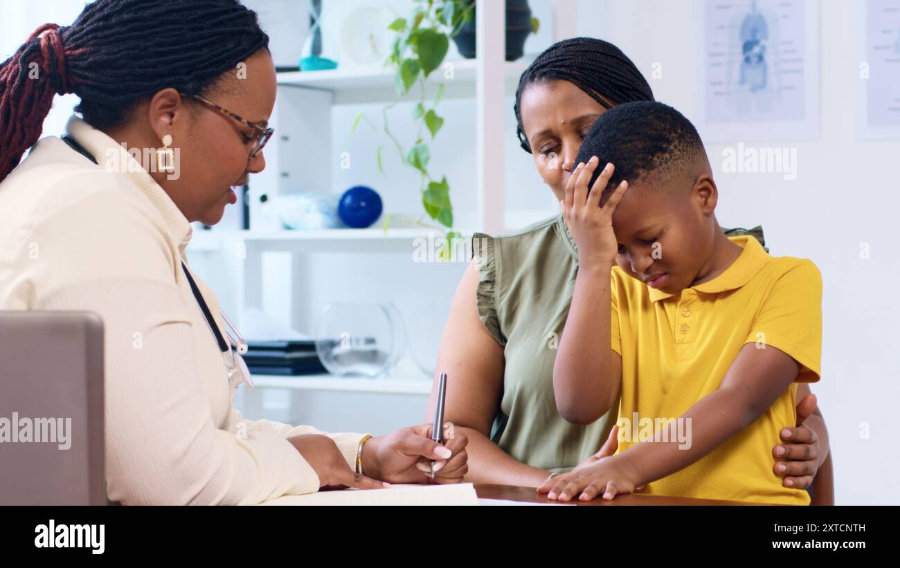 Concerned Young Boy Visiting Doctor with Mother in a Medical Office ...
