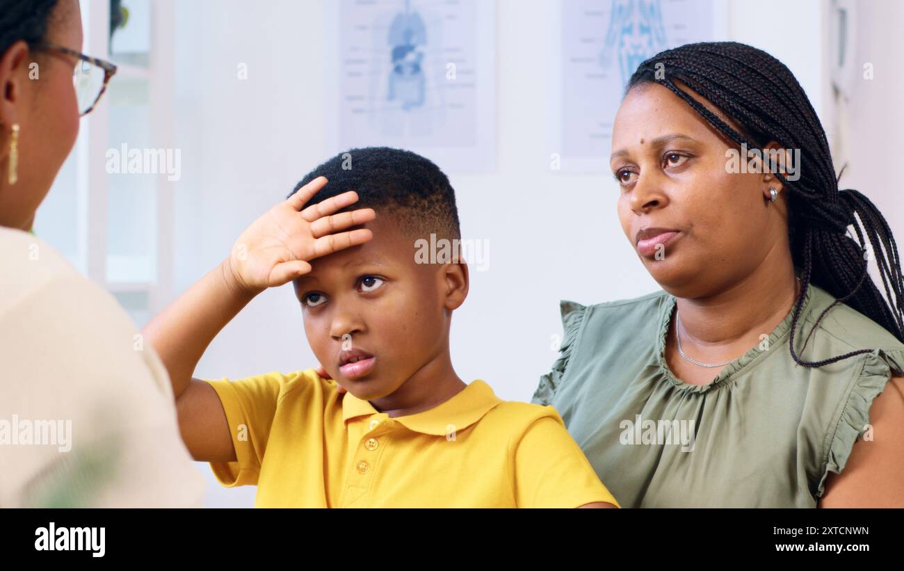 Concerned Mother and Child at Doctor's Office Consultation Discussing ...
