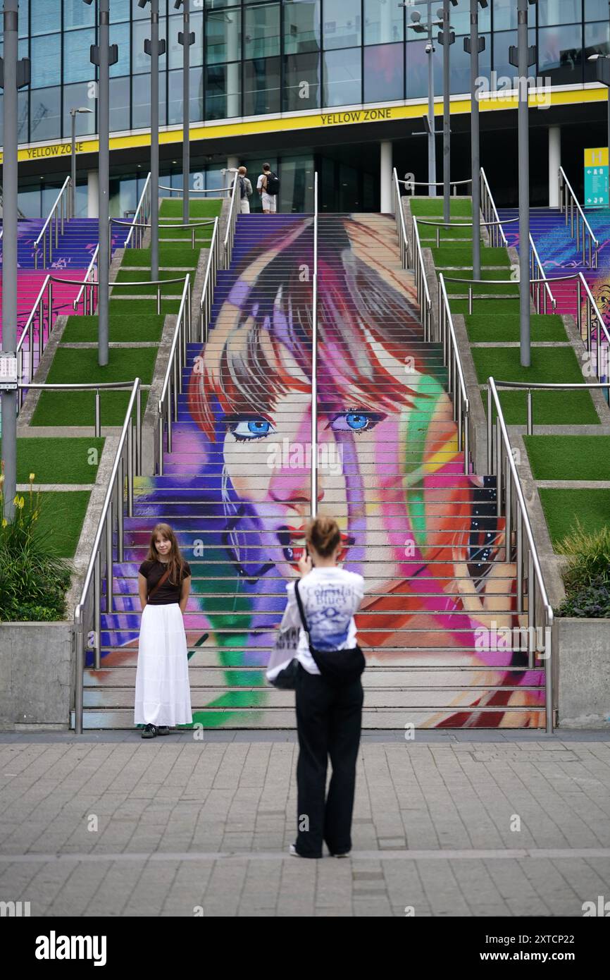 A Swiftie takes a photograph at the Swiftie Steps and murals at Wembley ...