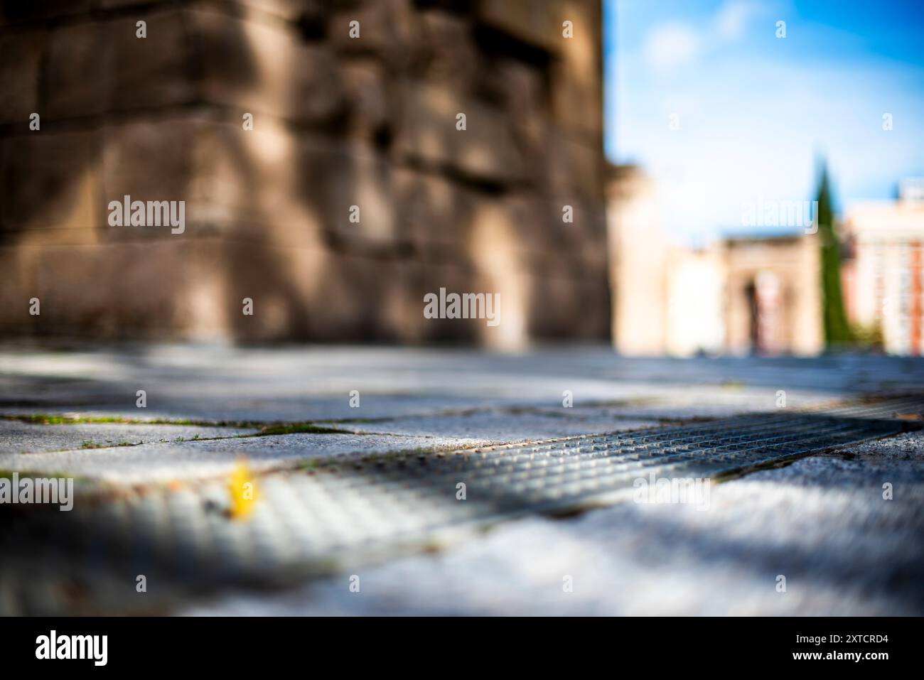 sidewalk with grate and stone wall in Madrid in Spain Stock Photo - Alamy