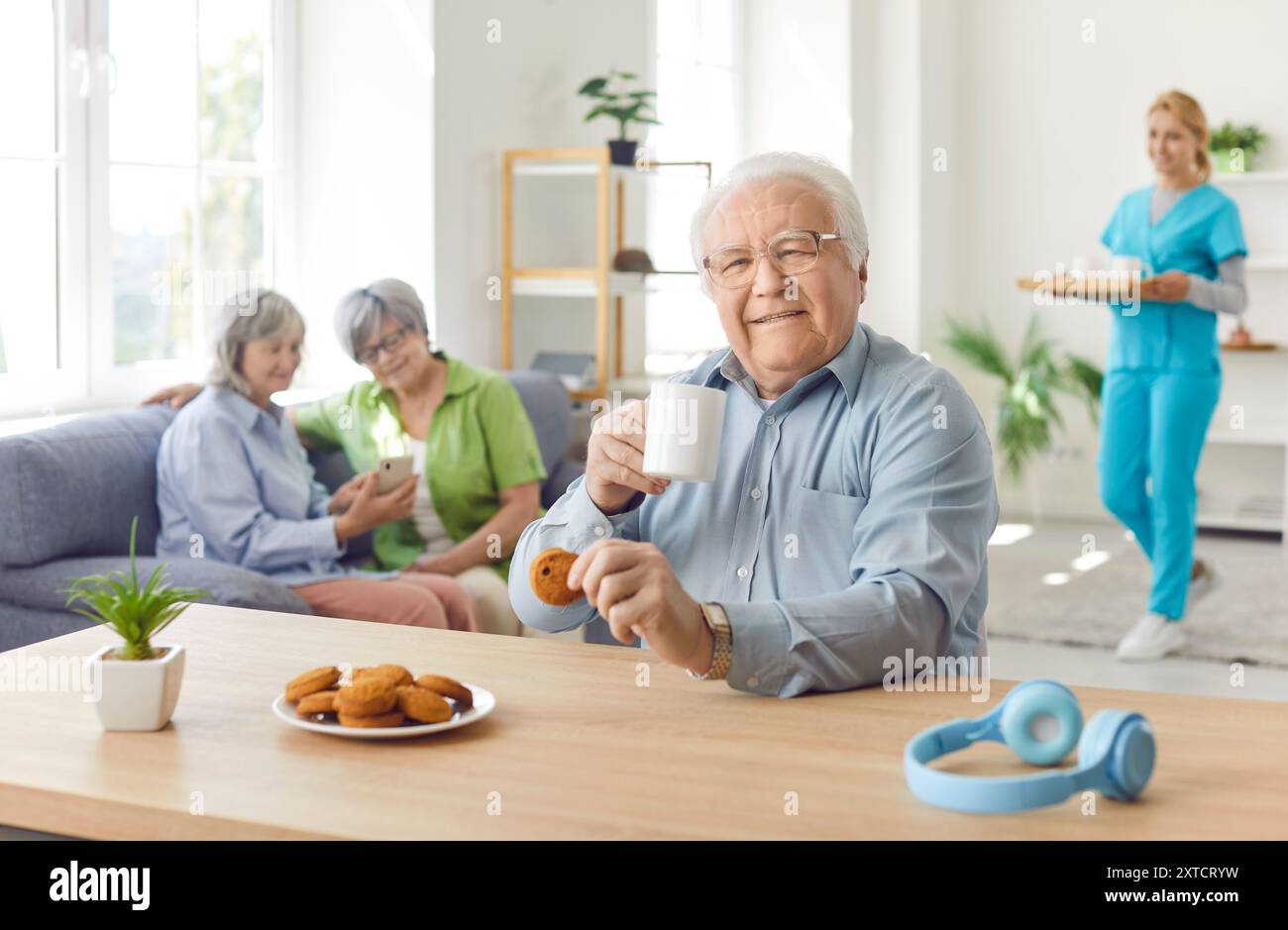 Happy senior mature patient at retirement home, drinking tea, doctor ...
