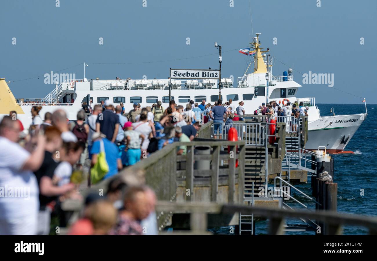 Binz, Germany. 14th Aug, 2024. Walkers are out and about on the pier in ...