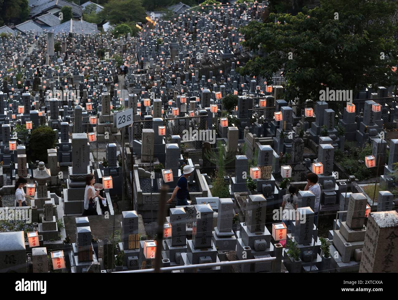 People visit graves during the Mandoue ceremony at Otani Mausoleum of ...