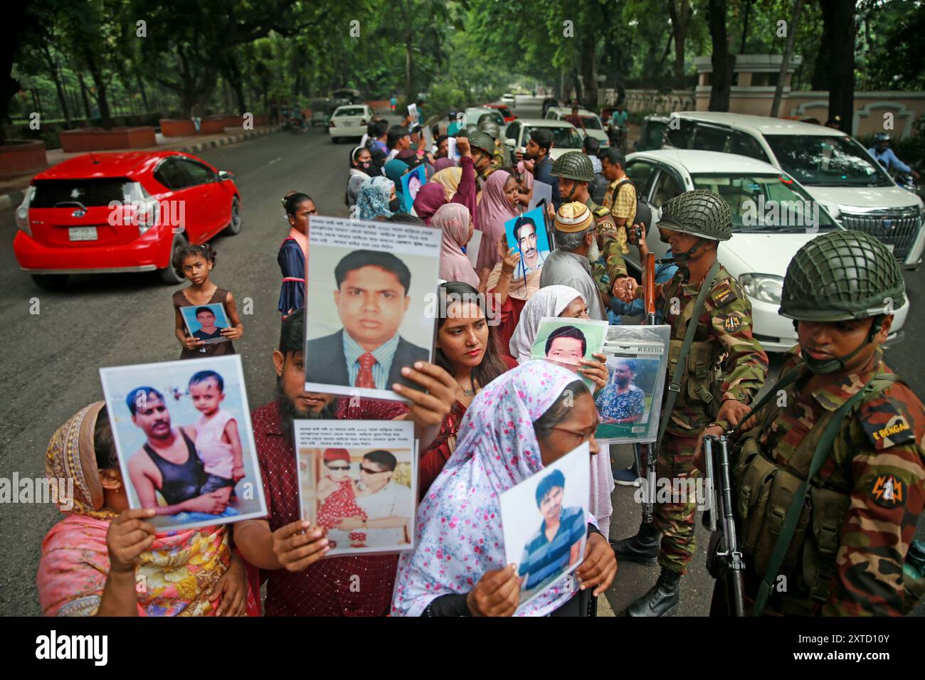 Family members of victims of enforced disappearances holding the ...