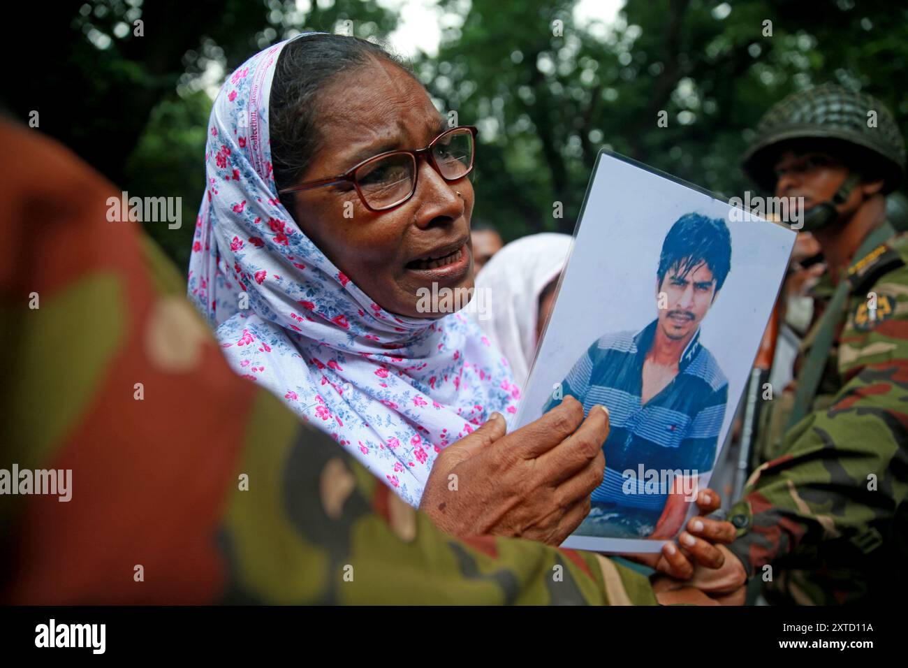 Family members of victims of enforced disappearances holding the ...