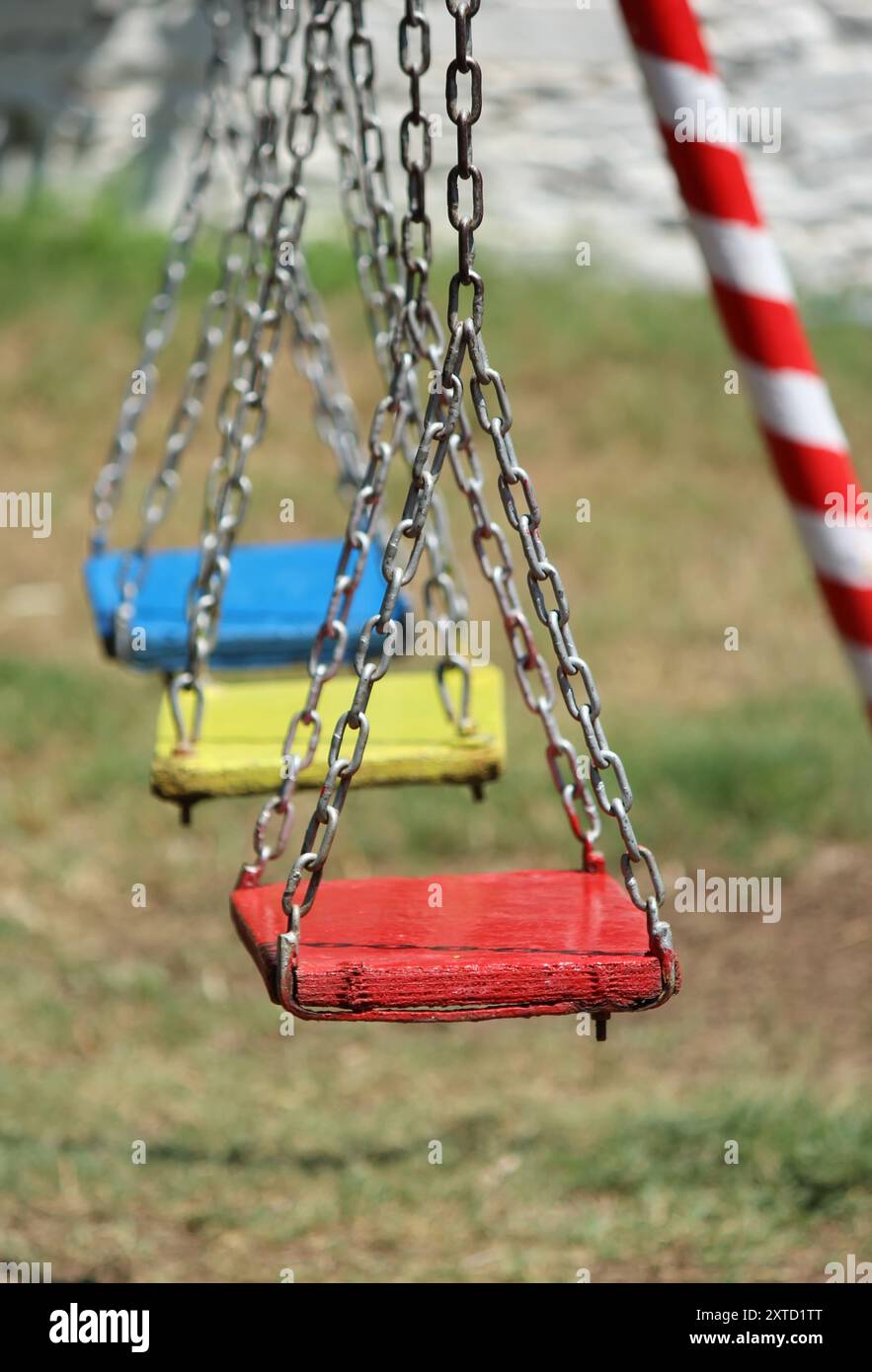 Happy children swinging in park hi-res stock photography and images - Alamy