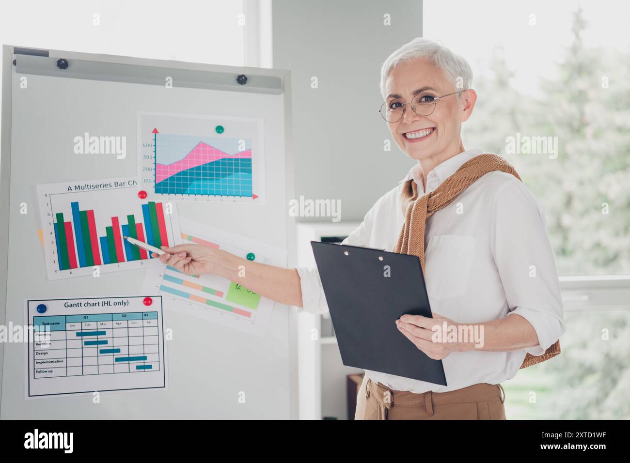 Photo of lovely senior lady presentation point boardroom graph marketer ...