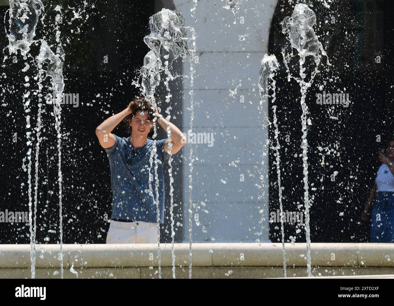 A man refresh himself in a fountain in Skopje, North Macedonia, 14 ...
