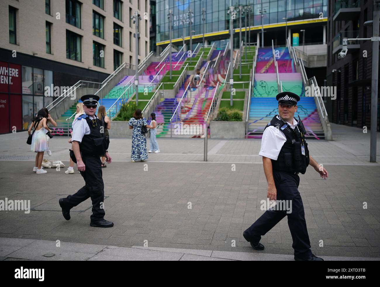 Police officers walk past the Swiftie Steps and murals at Wembley Park ...