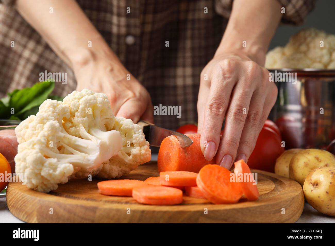 Woman cutting carrot hi-res stock photography and images - Alamy