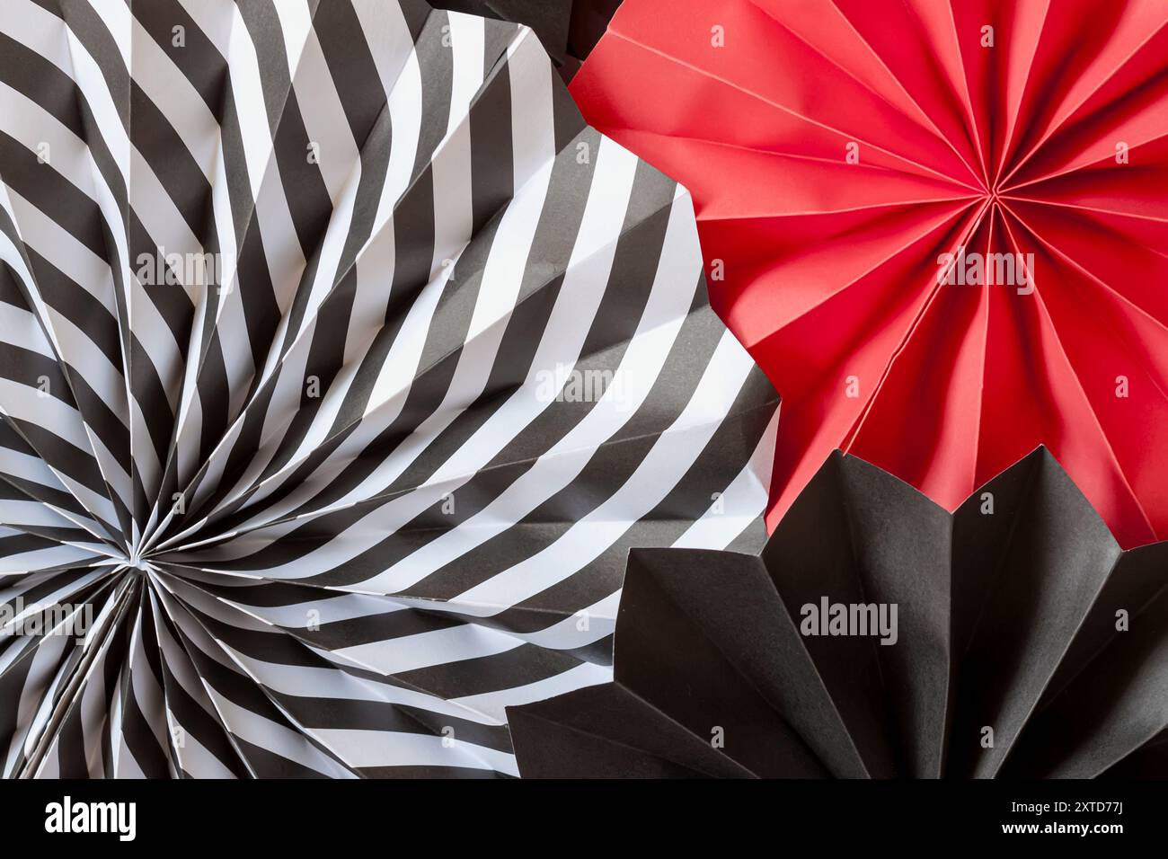 Bright and bold paper fan decorations in black, white, and red. Vibrant ...