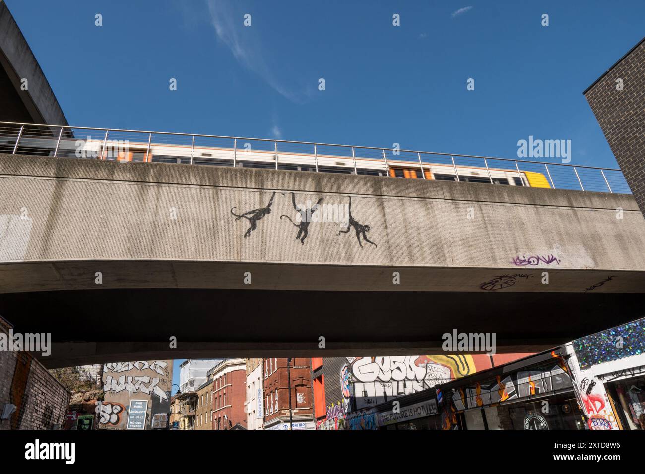 Banksy three swinging monkeys on railway bridge Brick Lane in ...