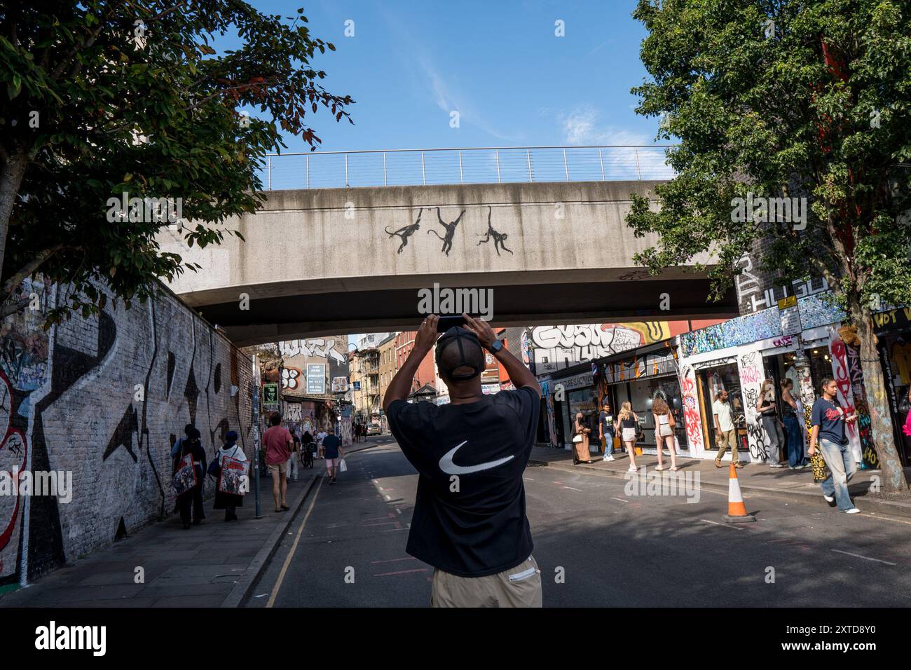 Banksy three swinging monkeys on railway bridge Brick Lane in ...