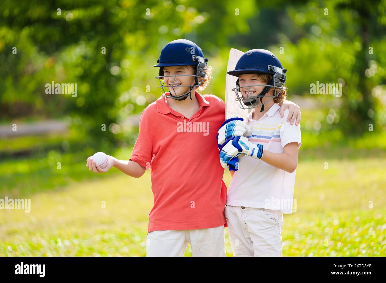 Kids playing cricket in summer park. Boy with bat and ball on cricket ...