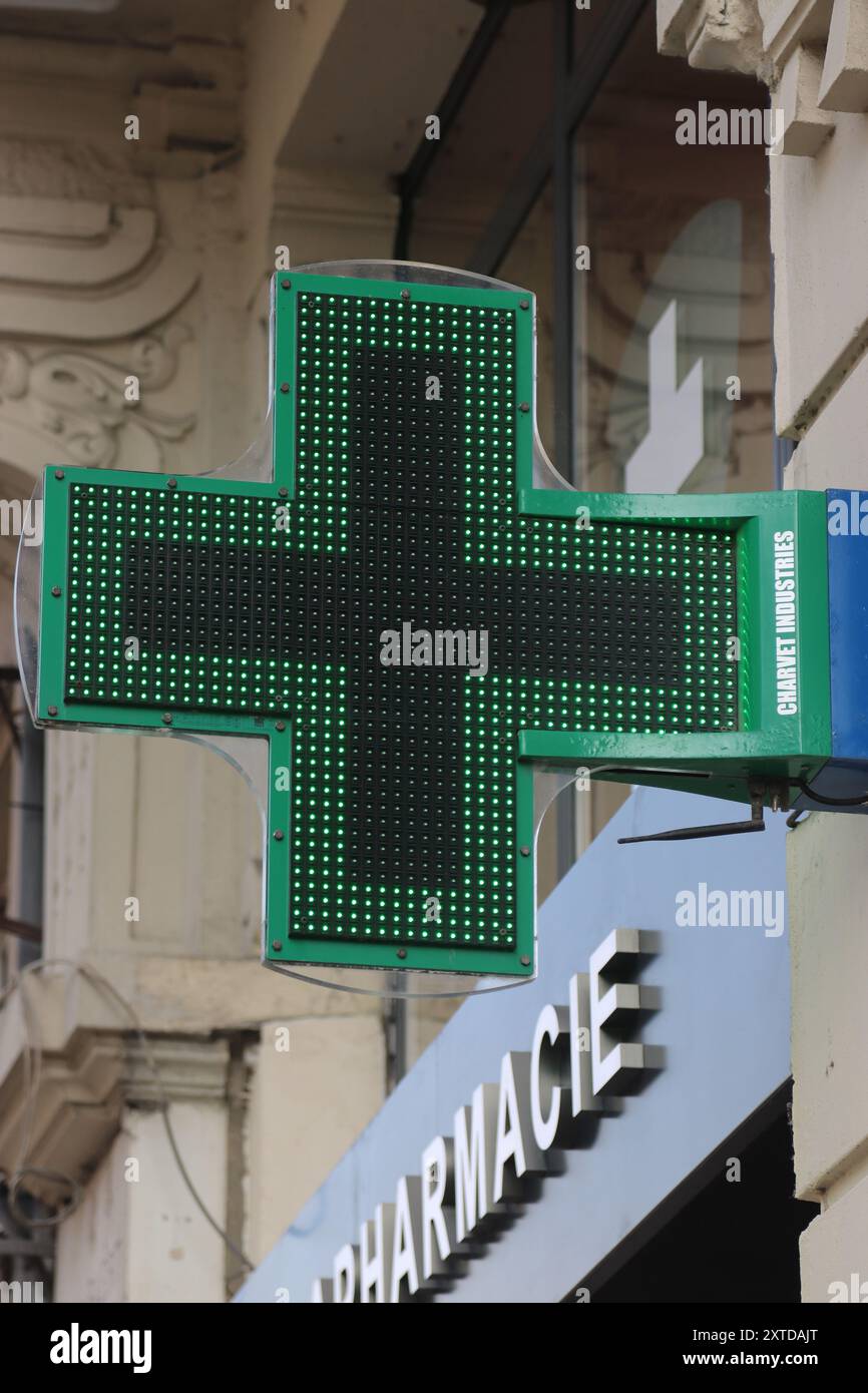 bright green cross sign advertising a pharmacy below Stock Photo - Alamy