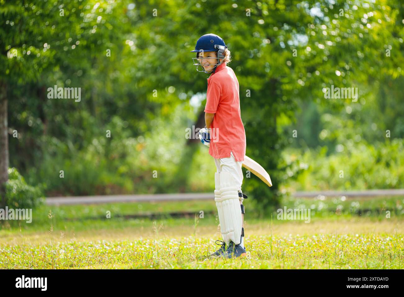 Kids playing cricket in summer park. Boy with bat and ball on cricket ...