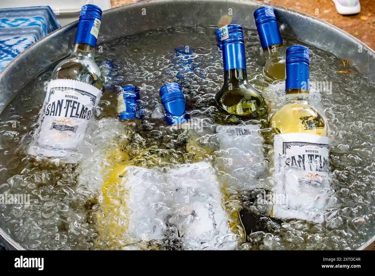 Bottle of white wine kept chilled in a vat of iced water Stock Photo ...