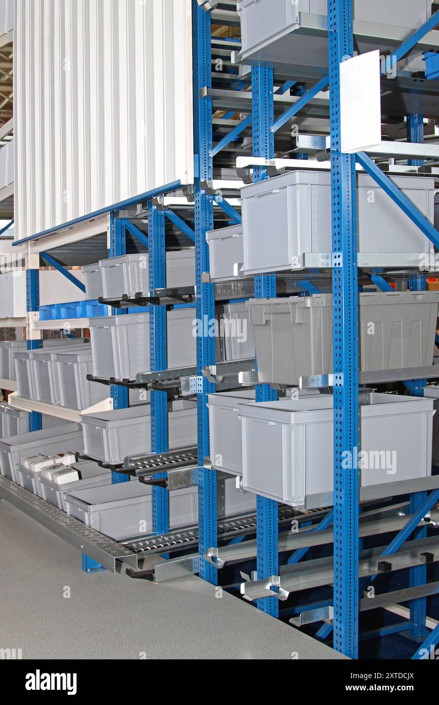 Plastic Boxes and Crates at Gravity Shelf in Storage Room Warehouse ...
