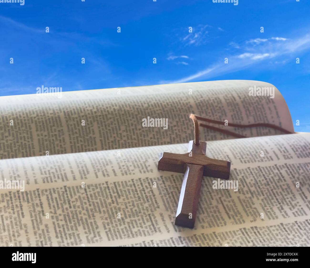 A brown wooden cross resting in an open palm, symbolizing the spreading ...