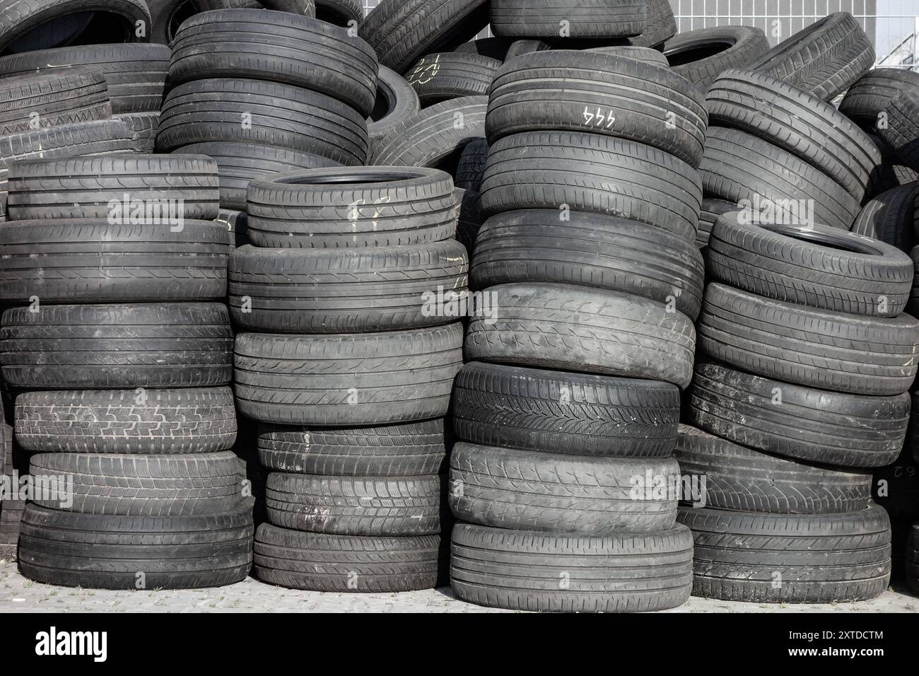 Piles of old rubber tyres, some with worn out treads Stock Photo - Alamy