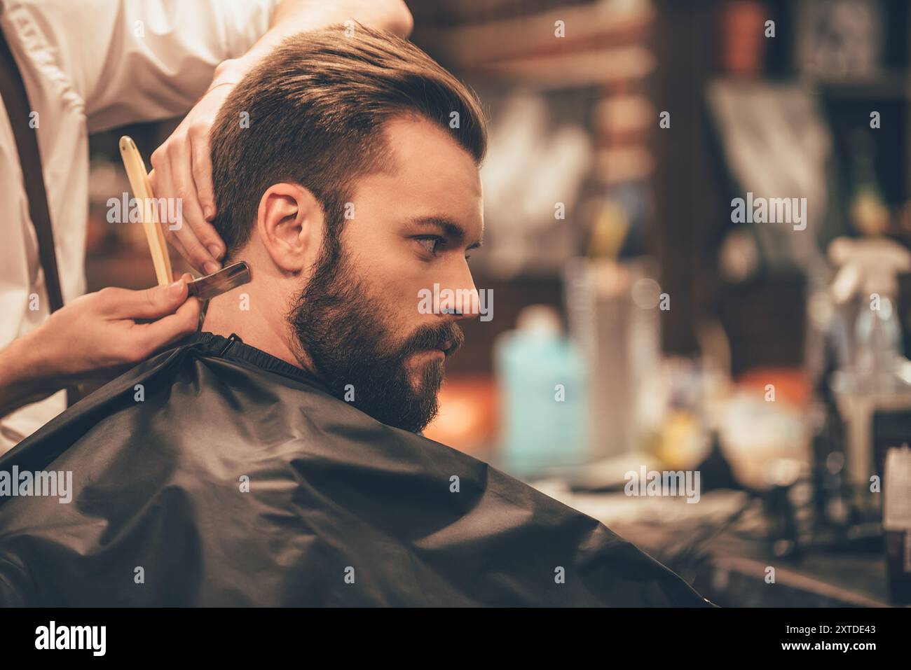 Making hair look magical. Close-up side view of young bearded man ...