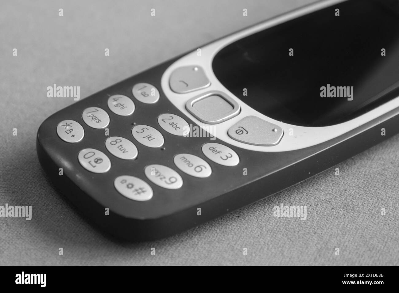 Vintage old fashioned push button mobile wireless telephone on wooden ...