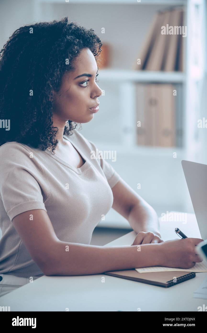 Making some important notes for a day. Close-up side view part of ...