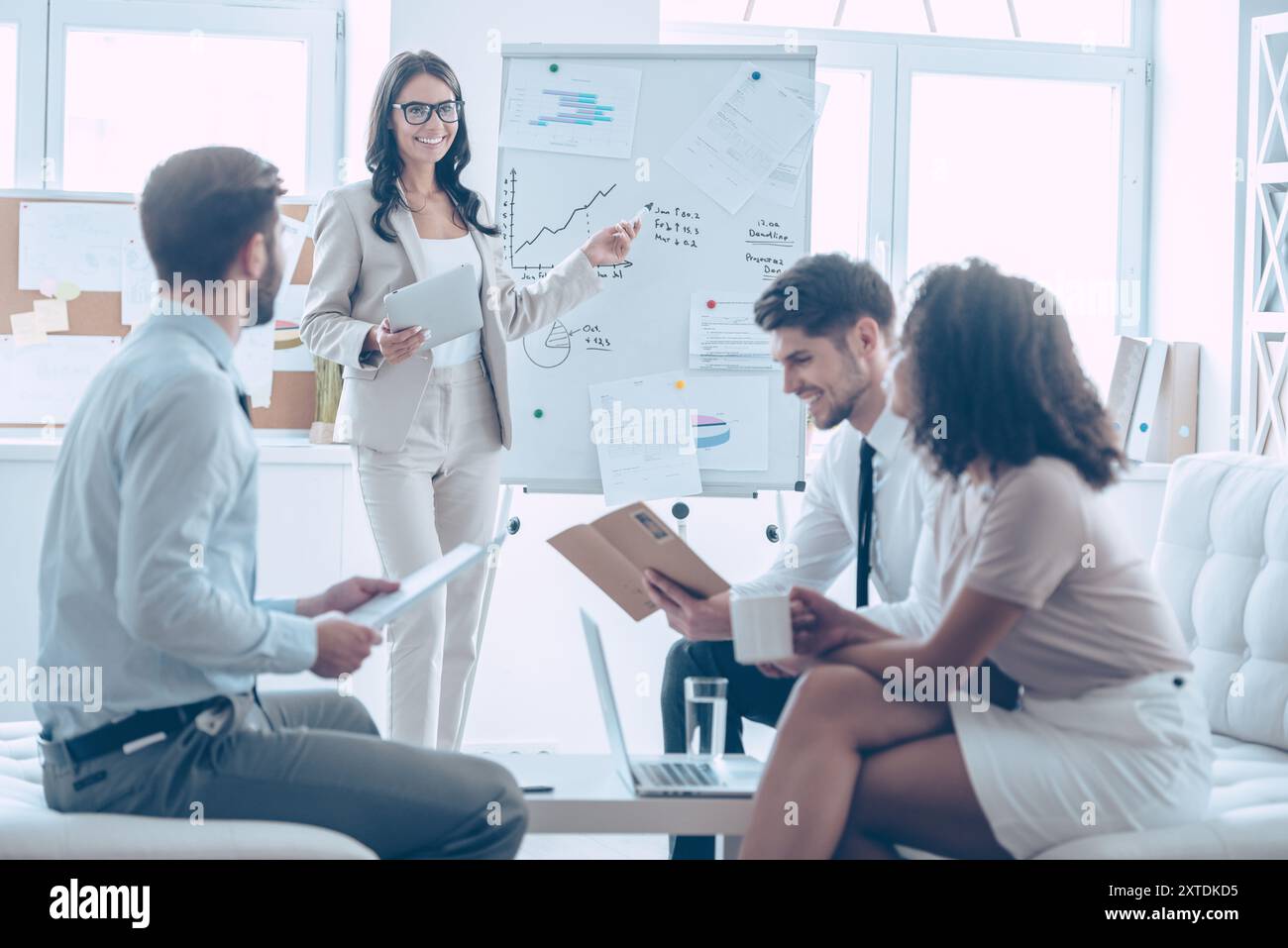 We can see growth here! Young beautiful cheerful woman pointing at ...