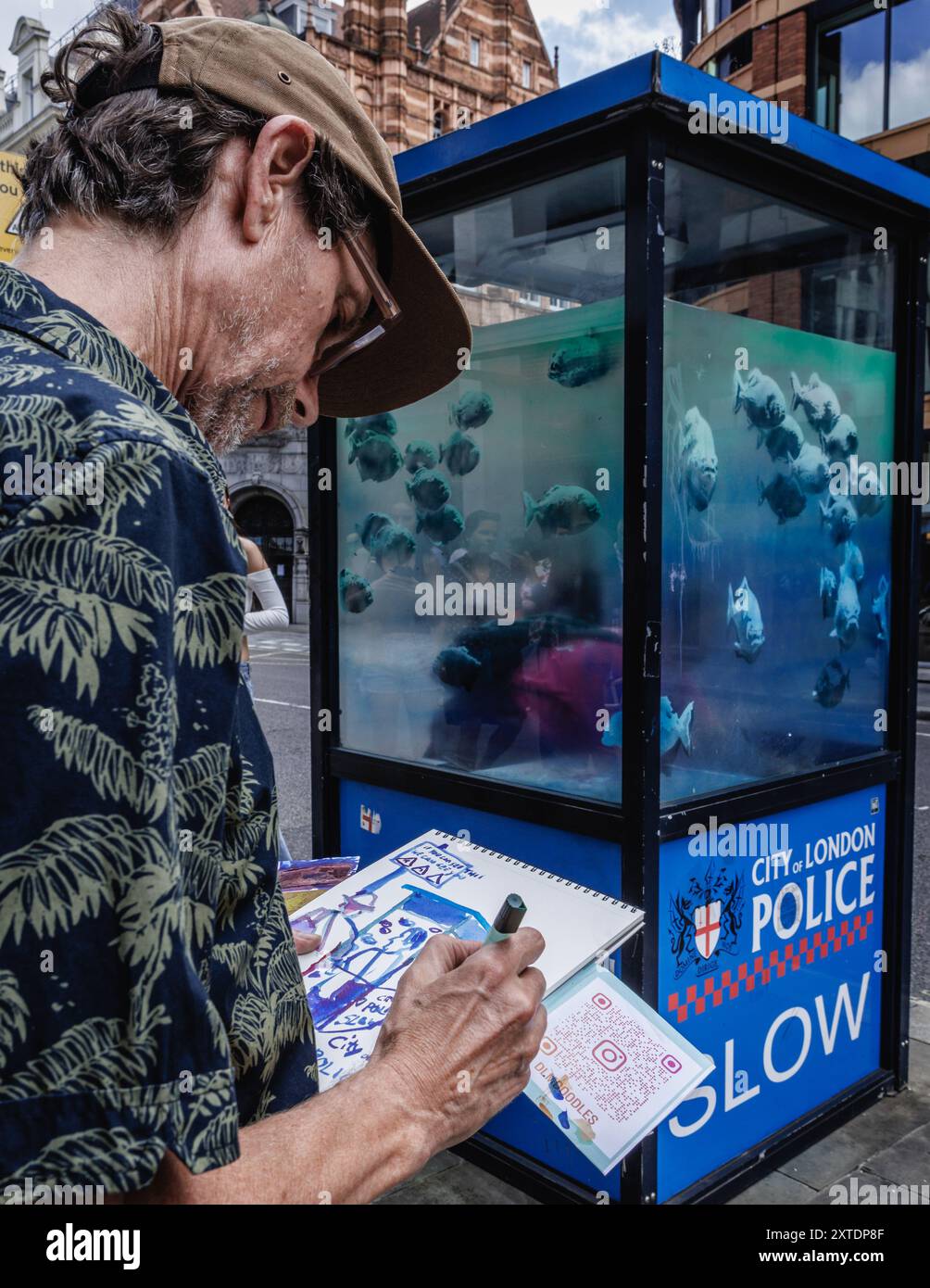 An artist sketches an impression of Banksy's Piranhas fish tank in the ...