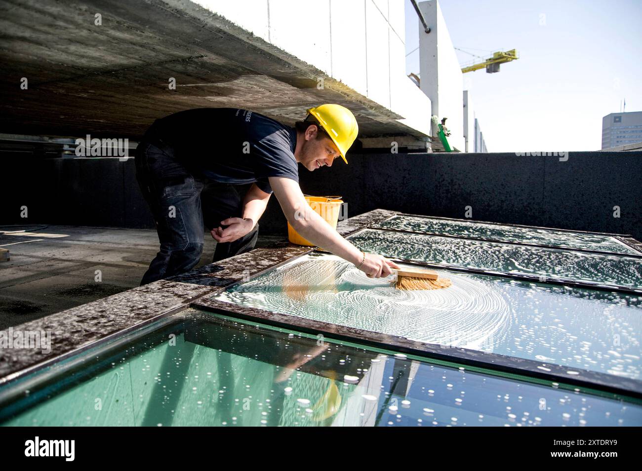 Window Cleaner working High Up Male, Caucasian Window Cleaner working ...