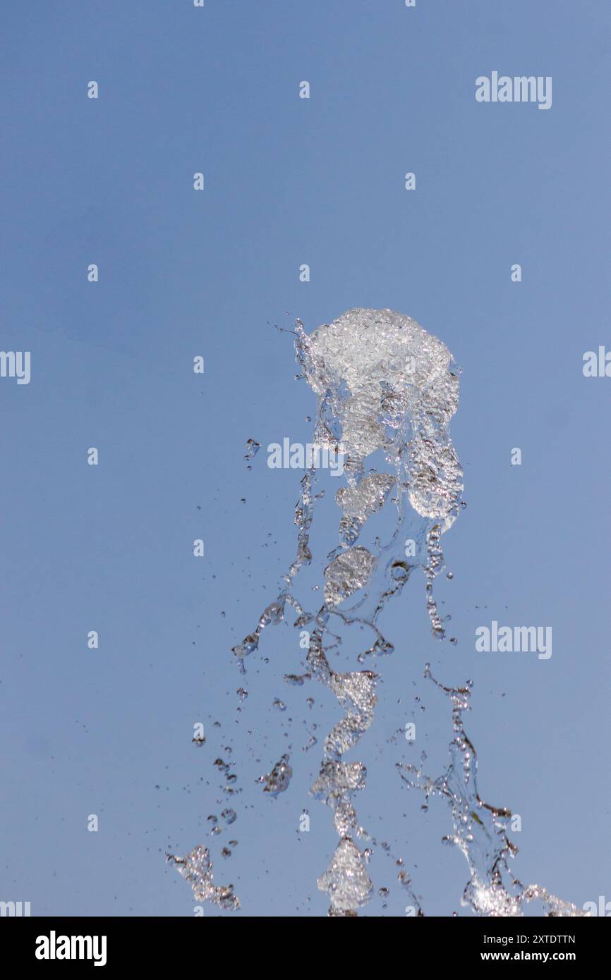 Clear blue sky with flying water droplets in a fountain Stock Photo - Alamy