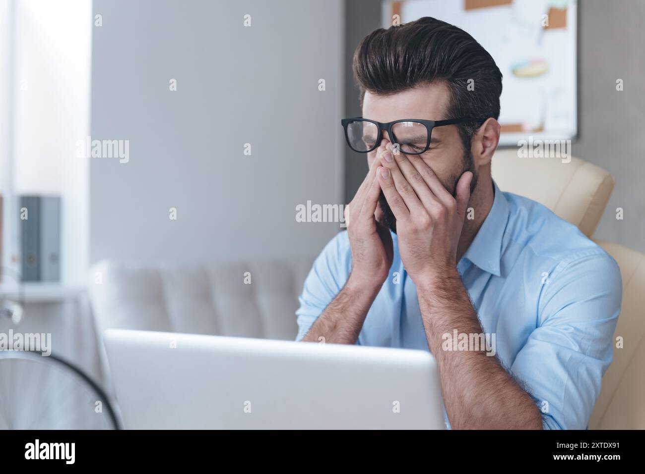 Feeling tired. Frustrated young handsome man looking exhausted and ...