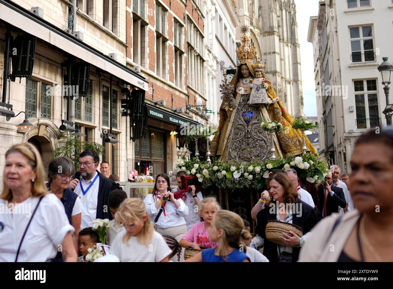 Bearers walk together as they carry a float during the Assumption of ...