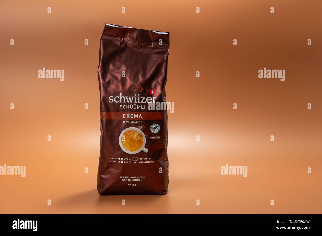 A bag of coffee beans from the brand Schweizer. The bag is brown and ...