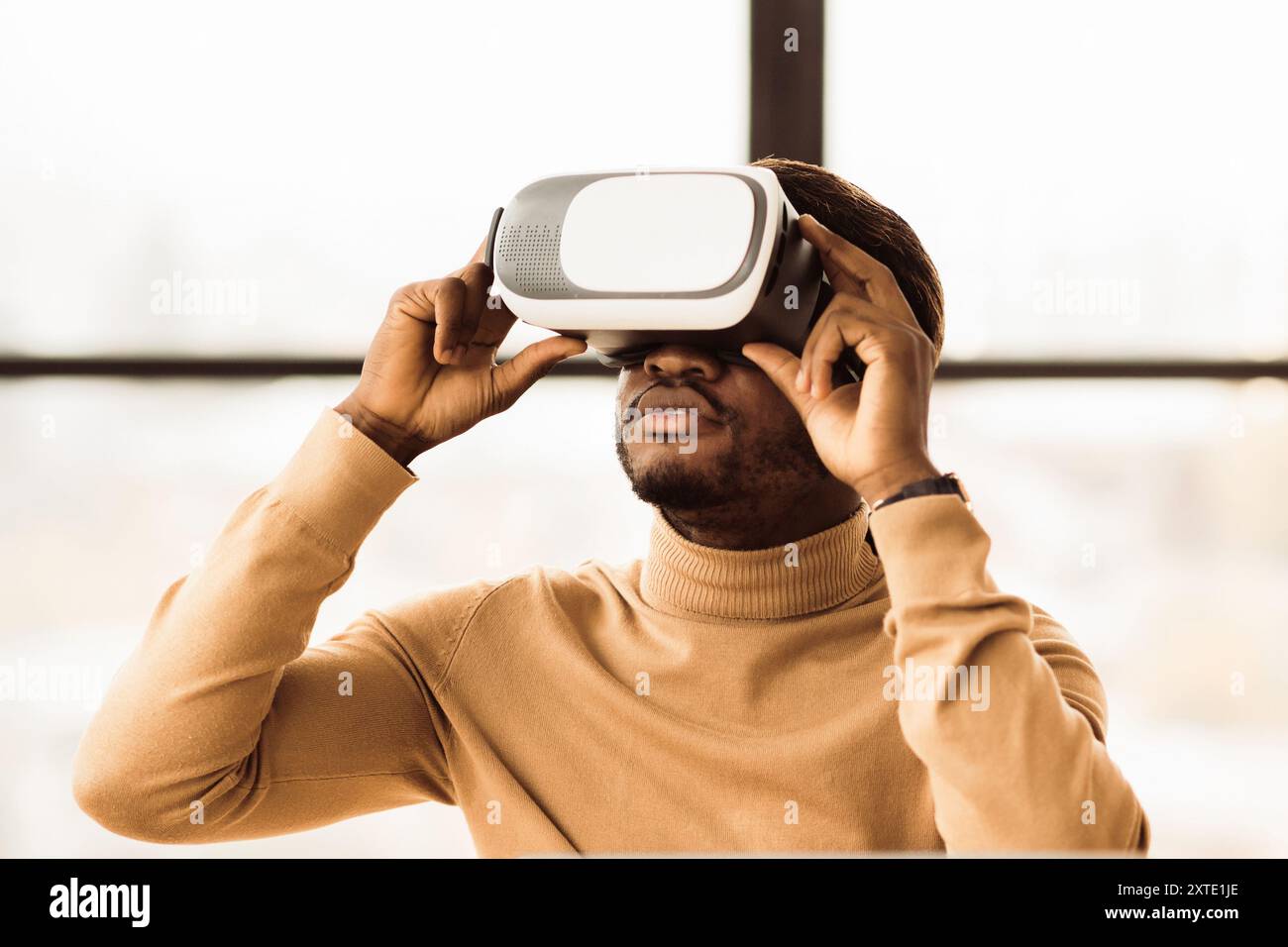 Afro businessman wearing augmented reality goggles at home Stock Photo ...
