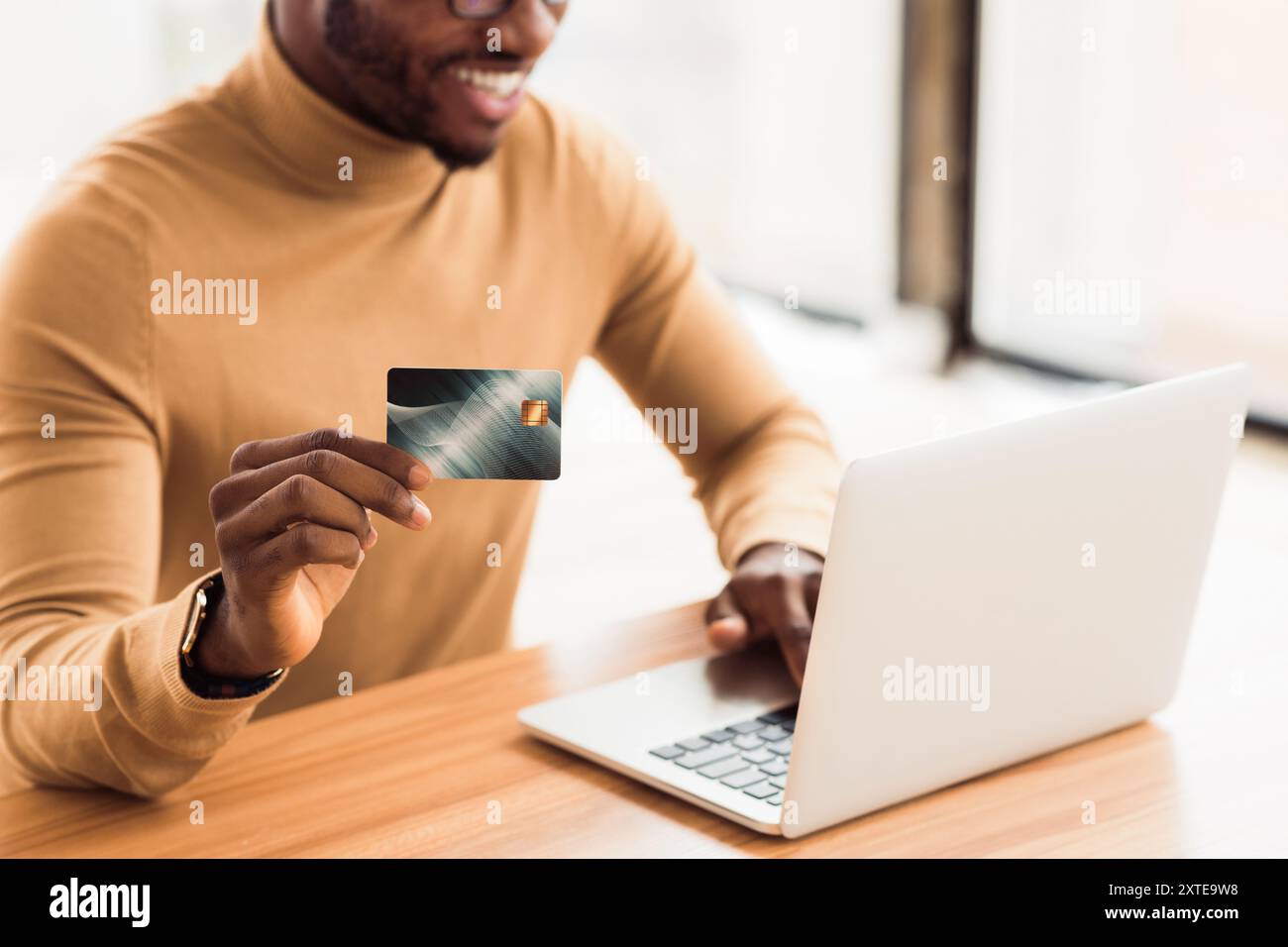 Black businessman making purchases using laptop computer Stock Photo ...