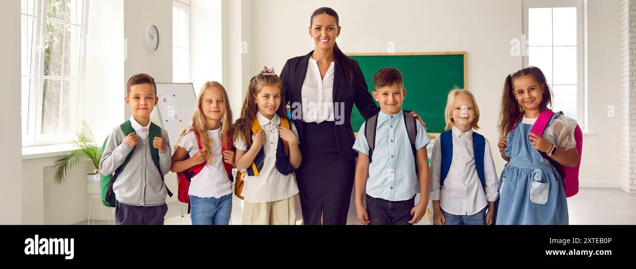 Happy school teacher and first grade students in class Stock Photo - Alamy