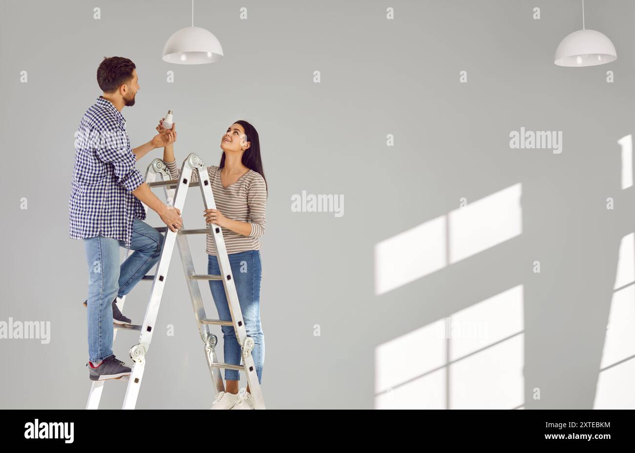 Man changing light bulb on ladder hi-res stock photography and images ...