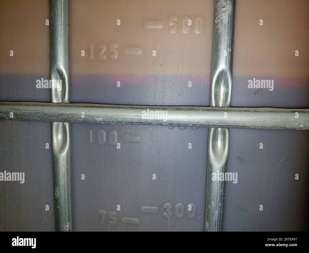 A plastic cube sits in a crate, showing the liquid level marked on the ...